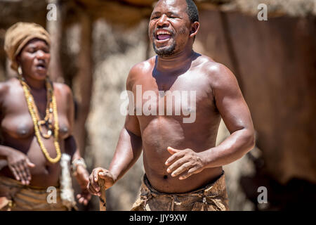 Men and women of the Damaraland tribe are performing traditional songs ...