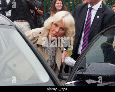 Queen Camilla shelters under an umbrella during a Big Lunch at the ...