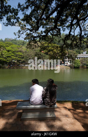 couple sitting on a bench by Kandy Lake Kandy Sri Lanka Stock Photo - Alamy