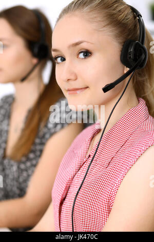 Call center. Focus on beautiful woman in headset Stock Photo - Alamy