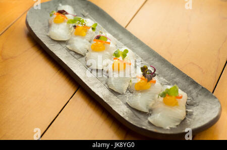 Elegant and colorful halibut sushi on plate, ready to eat Stock Photo ...