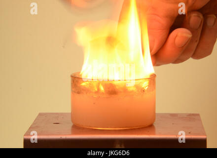Flame test. Calcium burning in the flame of a bunsen burner producing ...