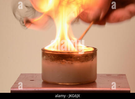 Flame test. Calcium burning in the flame of a bunsen burner producing ...