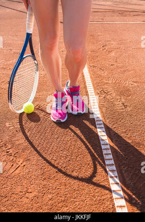 Beautiful young woman with racket and ball at tennis court Stock Photo ...