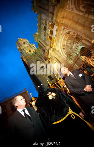 A penitent from the Santa Maria de la Alhambra Brotherhood dressed in ...