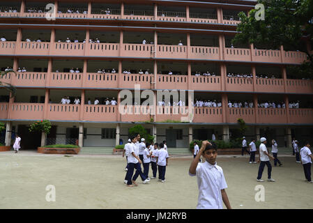 Bangladeshi school students walking on the school ground at class break ...