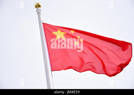 A Chinese flag is raised during a medal ceremony for the women's ...
