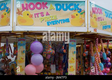 Hook a Duck stall at a fun fair in the UK with a selection of prizes on ...