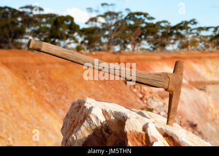 Miner pickaxe tool for mining work hitting rocks symbol on dark stone ...