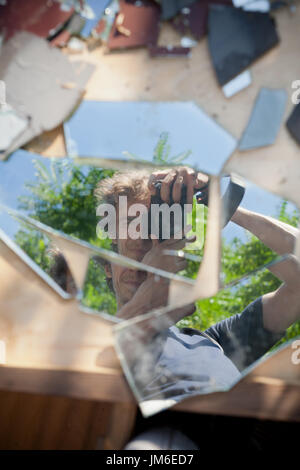 Wooden hand with mirror on light background Stock Photo - Alamy