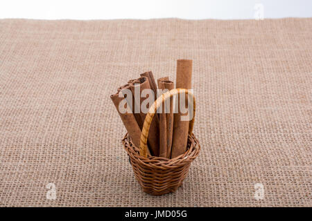bundle of cinnamon sticks on a linen canvas background Stock Photo - Alamy