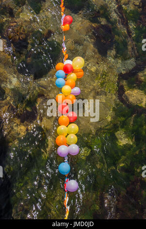 Balloons in shooting range as targets on water Stock Photo - Alamy