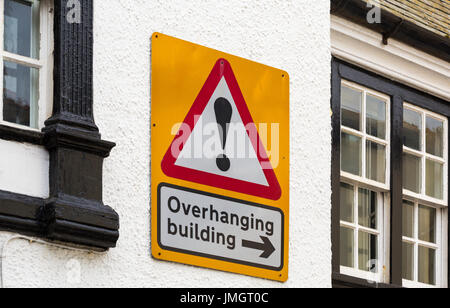 Warning road sign for overhanging building and balcony in town of ...