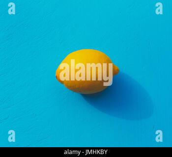 Single fruit on blue chop board aerial view Stock Photo - Alamy