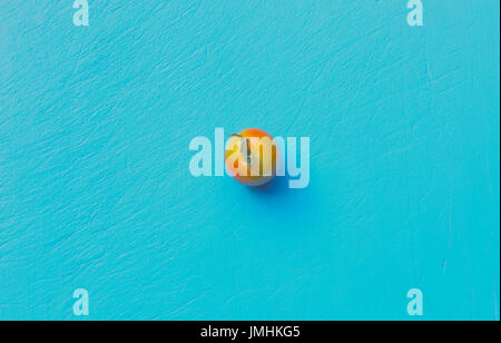 Single fruit on blue chop board aerial view Stock Photo - Alamy