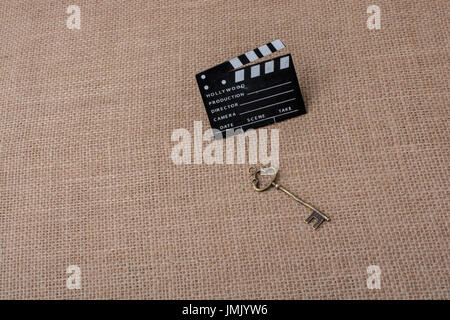 Movie clapper and retro key on canvas background Stock Photo - Alamy