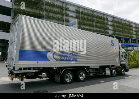 A Sagawa Express delivery truck drives past the Sagawa headquarters ...