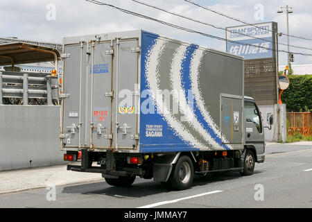 A Sagawa Express delivery truck drives past the Sagawa headquarters on ...