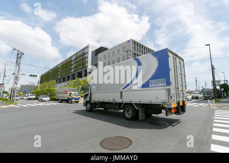 A Sagawa Express delivery truck drives past the Sagawa headquarters on ...