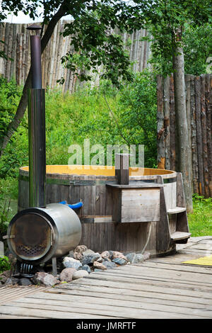 Bath barrel with a stove Stock Photo - Alamy