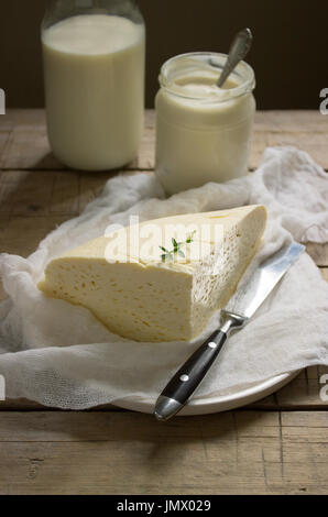 Dairy farm - table with dairy products in background of cows in stall ...