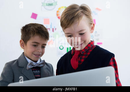 Kids as business executives using laptop in office Stock Photo - Alamy