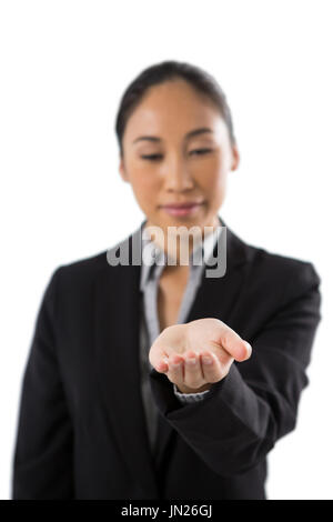 Female executive holding invisible object against white background ...