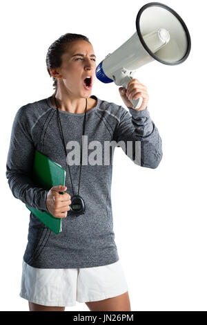 Young pretty woman with a megaphone against blue background in studio ...