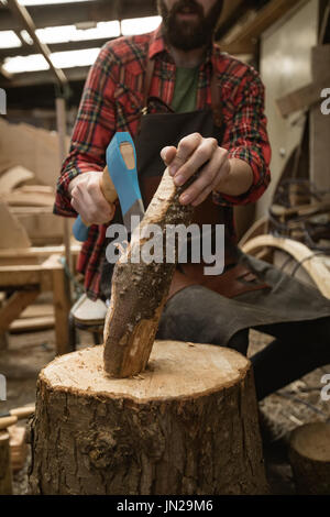 Carpenter with axe working with log wooden. Woodwork job, house frame ...