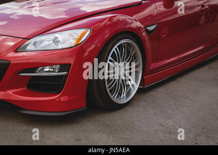 Cherry red car front detail with big light-alloy wheel Stock Photo - Alamy
