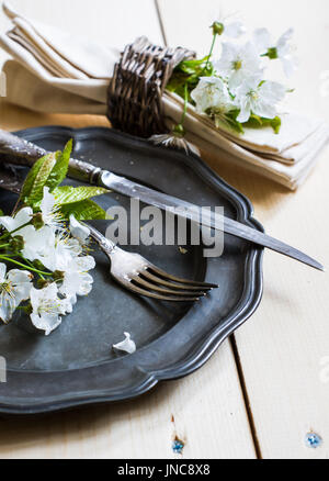Spring time table setting with cherry blossom and vintage silverware on ...