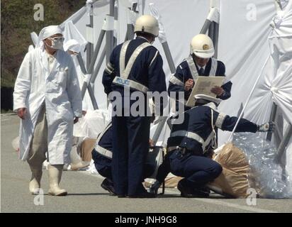 KIYOMI, Japan - Policemen check white-robed vehicles of Pana Wave ...