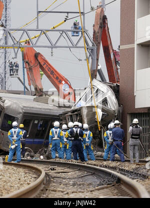 AMAGASAKI, Japan - A West Japan Railway Co. train passes the April 25 fatal derailment accident ...