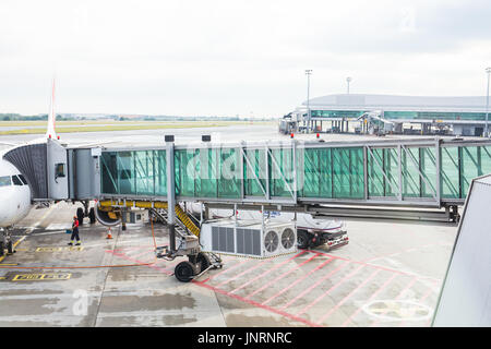 Aircraft with passage corridor/tunnel being prepared for departure from ...