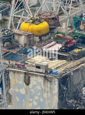 This photo shows the damaged Unit 1 reactor, back, and part of the ...