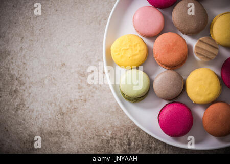 colorful macaroon cookies on concrete background, top view Stock Photo ...