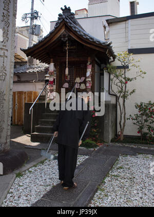 Female monk in Kyoto, Japan. Holding shakujo staff, wearing a gasa ...