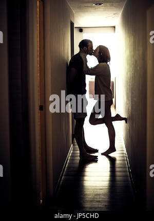 Silhouette of couple standing in corridor in crisis. Parents with child ...