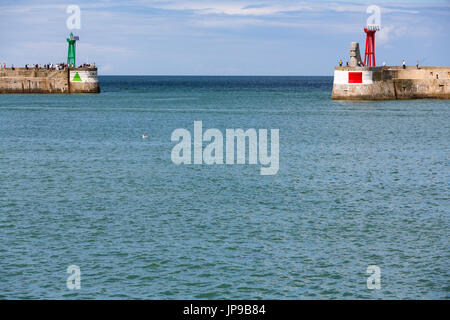 Seawall with red and green lighthouses in Fance, Normandy Stock Photo ...