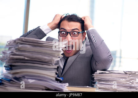 Busy angry businessman with heaps of paper Stock Photo - Alamy