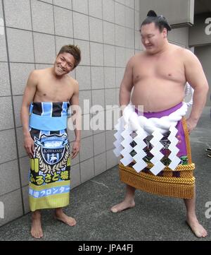 Mongolian sumo wrestler Hakuho, wearing a grand champion's ceremonial ...