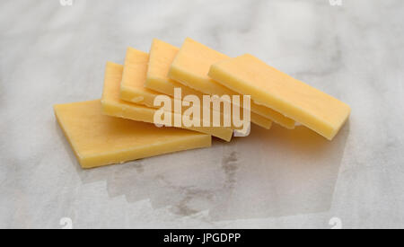 Side view of several slices of gouda cheese in a row isolated on a ...
