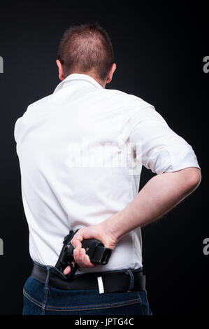 gangster concealing his gun behind his back. back and white photo Stock ...