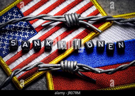Word SANCTIONS on USA flag Stock Photo - Alamy