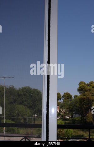 Installing mosquito nets for plastic windows Stock Photo - Alamy