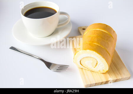 Swiss roll and coffee on white background Stock Photo - Alamy