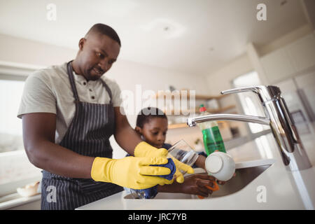 Father and son cleaning utensils at home Stock Photo - Alamy