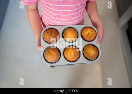 Mid section of boy holding muffins Stock Photo - Alamy