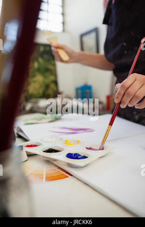 Woman painting in drawing book Stock Photo - Alamy
