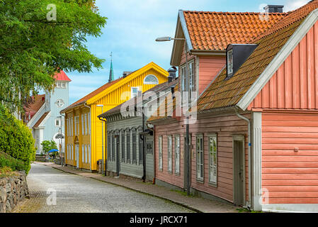 small town street scene with a road sign in the foreground and ...
